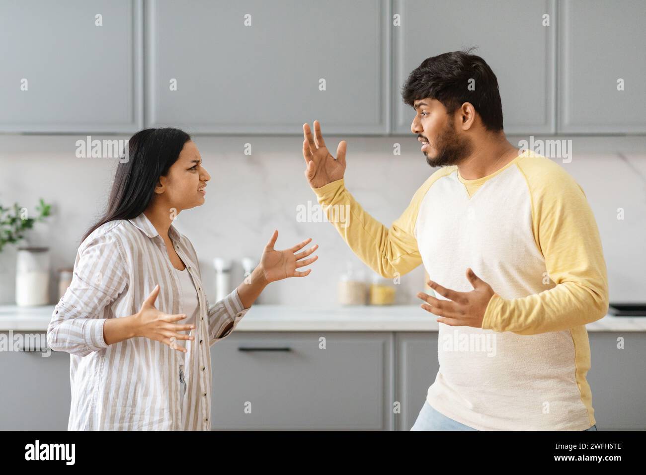 Emotional young indian couple fighting at kitchen Stock Photo - Alamy