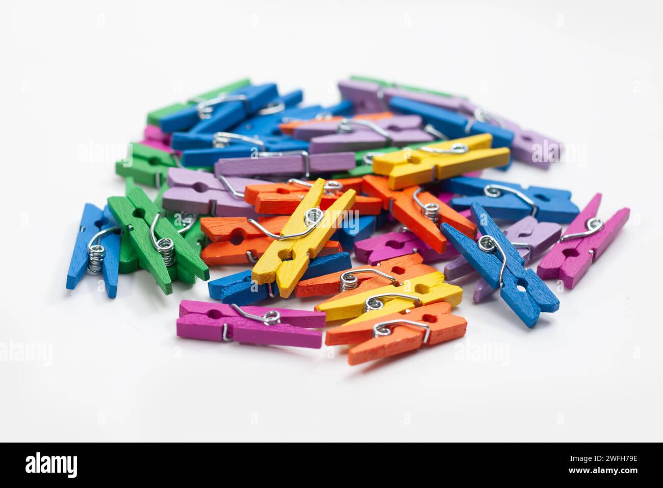 many colorful clothes pegs isolated on white background Stock Photo - Alamy