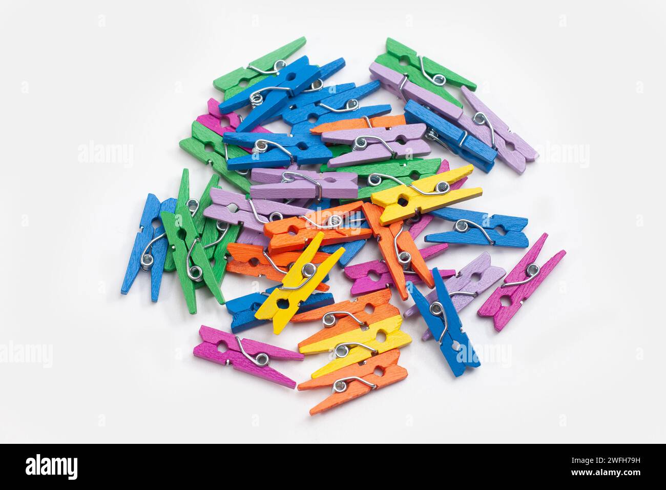 many colorful clothes pegs isolated on white background Stock Photo - Alamy