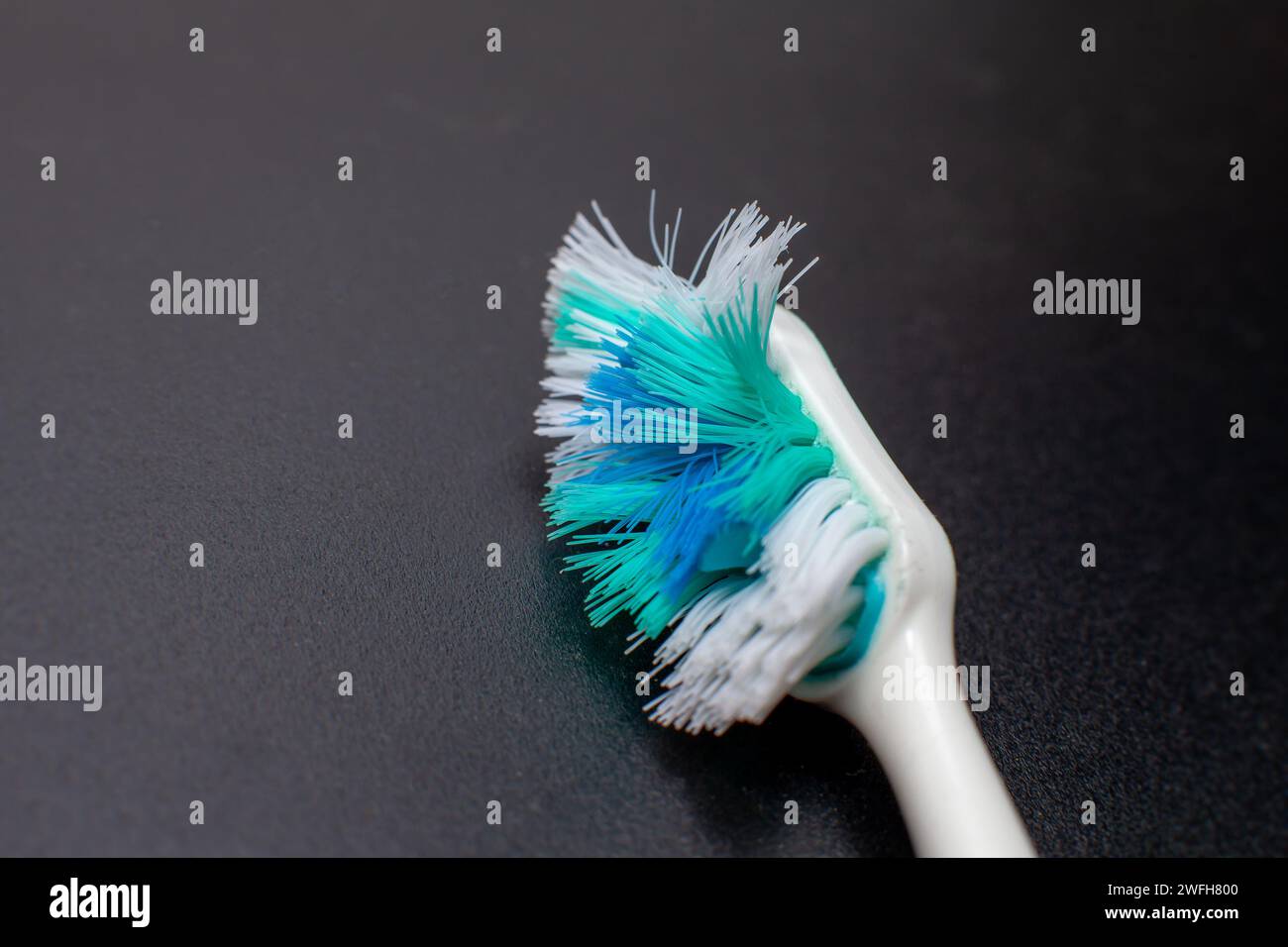 used toothbrush isolated on dark background Stock Photo - Alamy