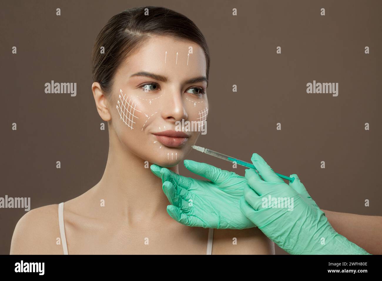 Beautiful woman with arrow lines on her face for lifting skin and ...