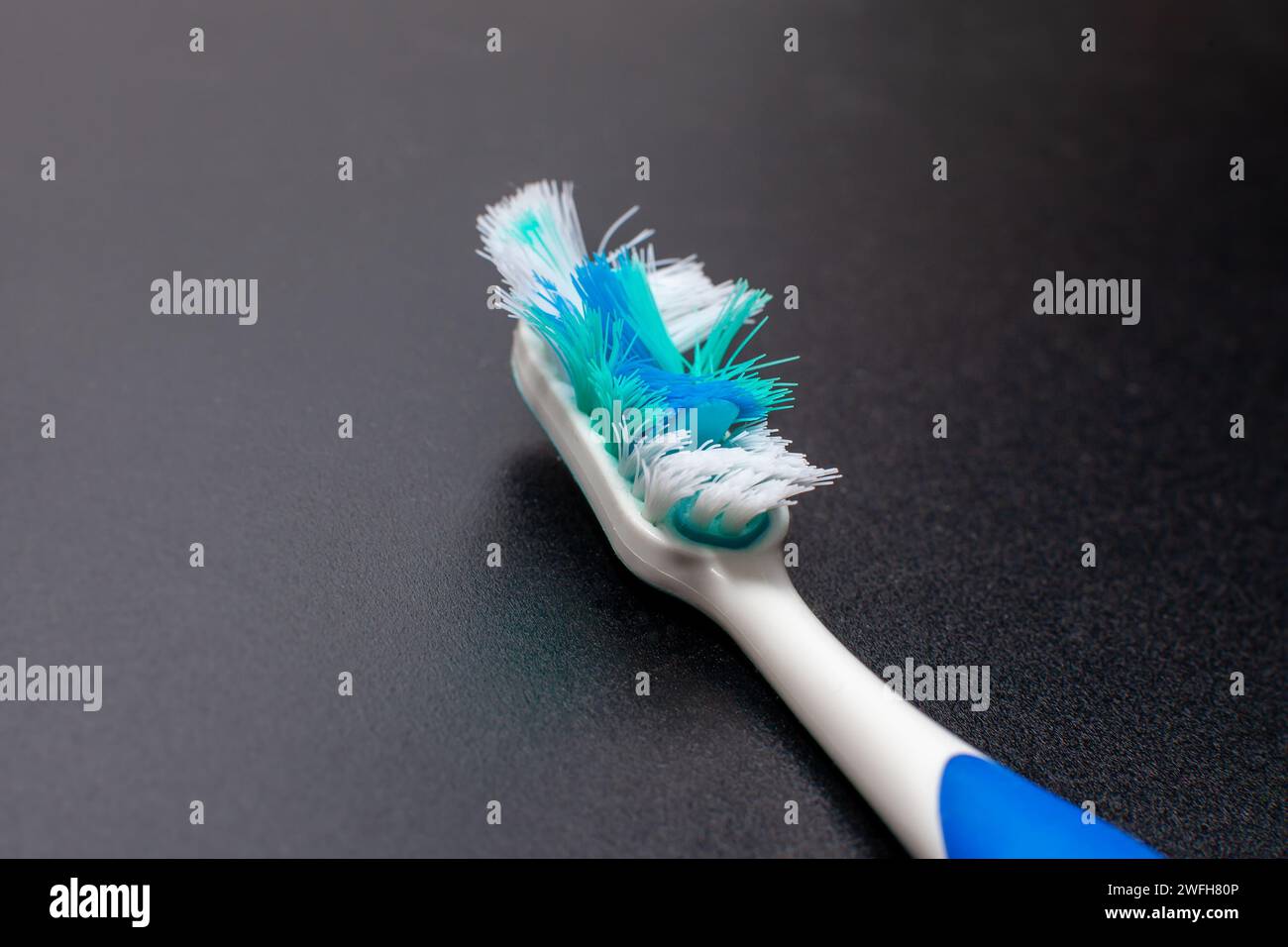 used toothbrush isolated on dark background Stock Photo - Alamy