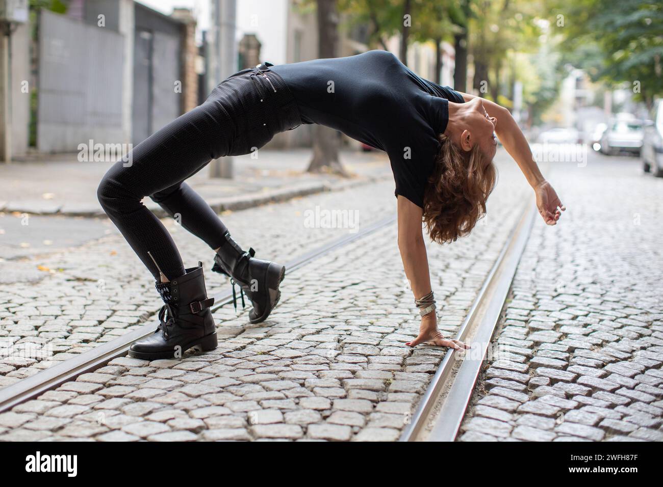 fit woman performing a back flip on street Stock Photo - Alamy