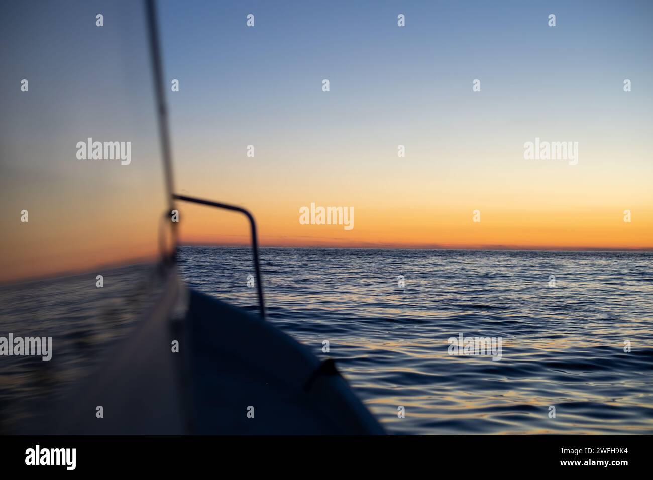 fishing boat going into the sunset Stock Photo - Alamy
