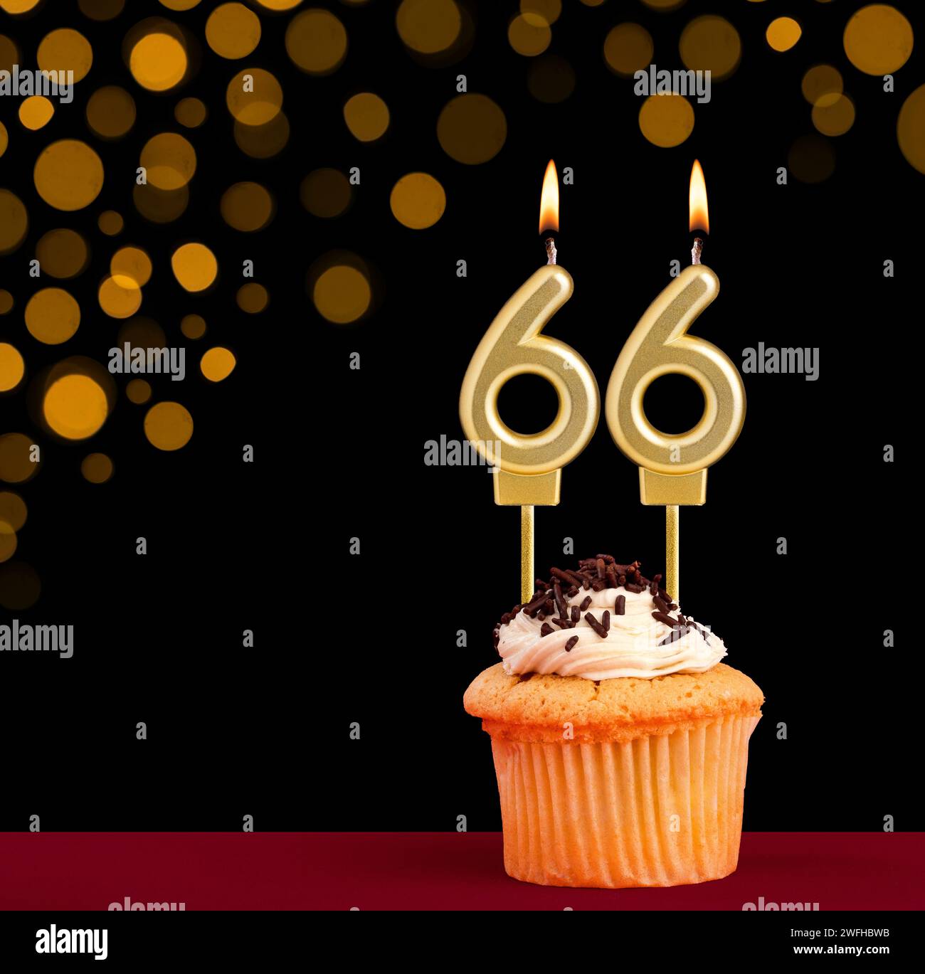 Birthday candle with cupcake - Number 66 on black background with out ...