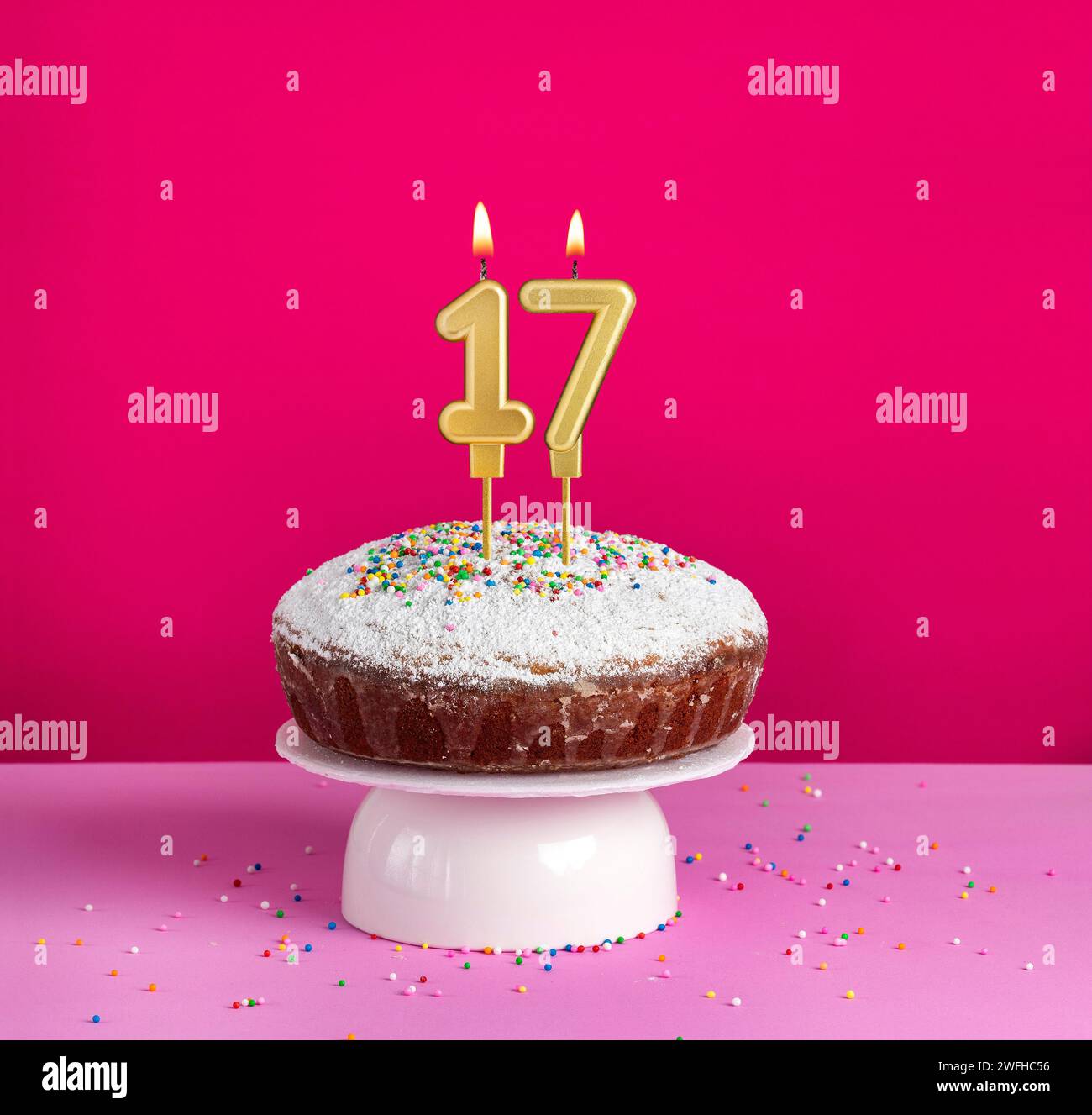 Birthday cake with number 17 candle on pink background Stock Photo - Alamy