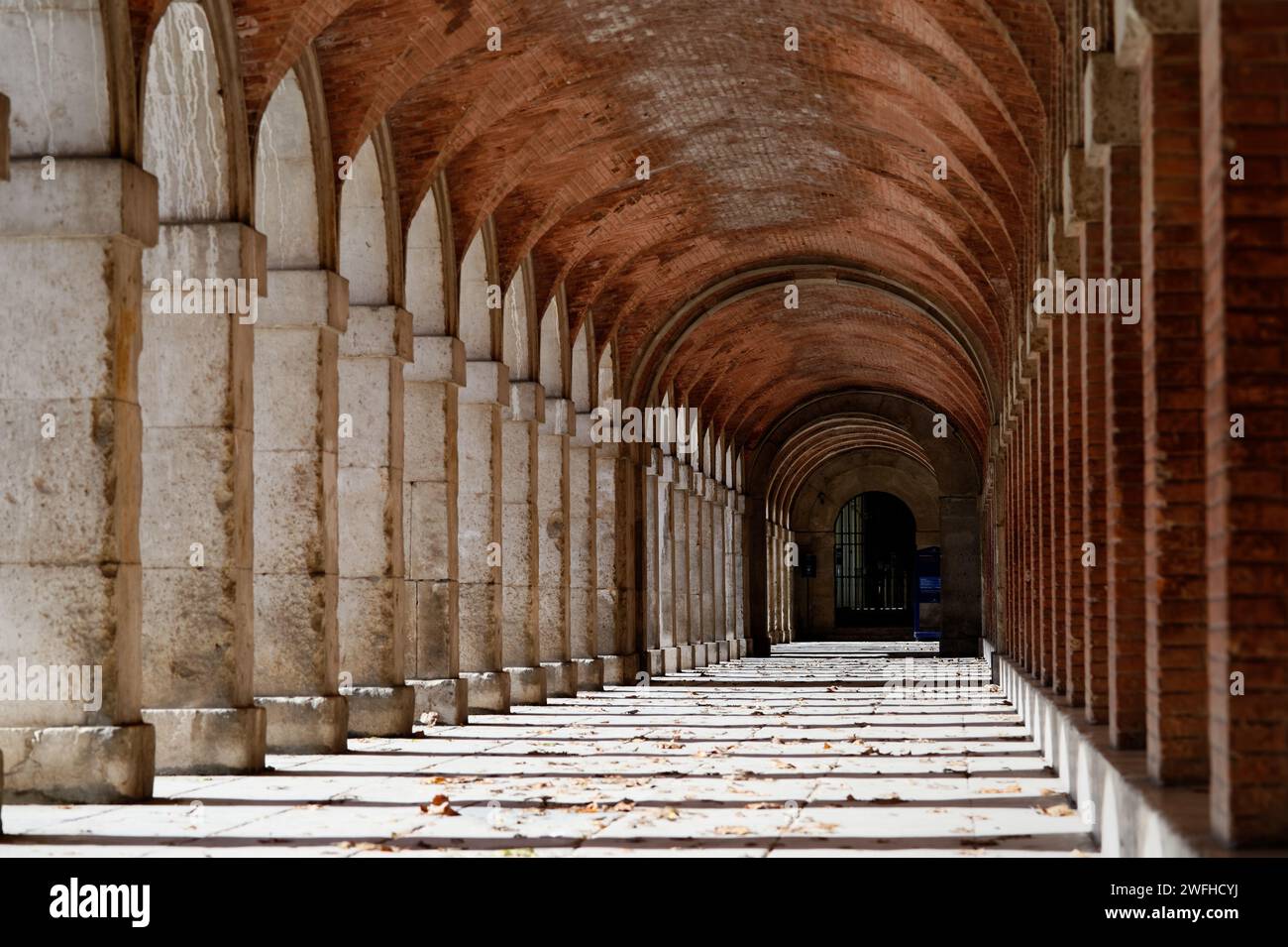 White concrete pillars and brick arches line arched passageways Stock ...