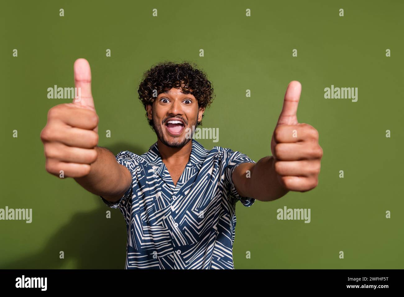 Photo of young overjoyed impressed guy makes like respect you symbols ...