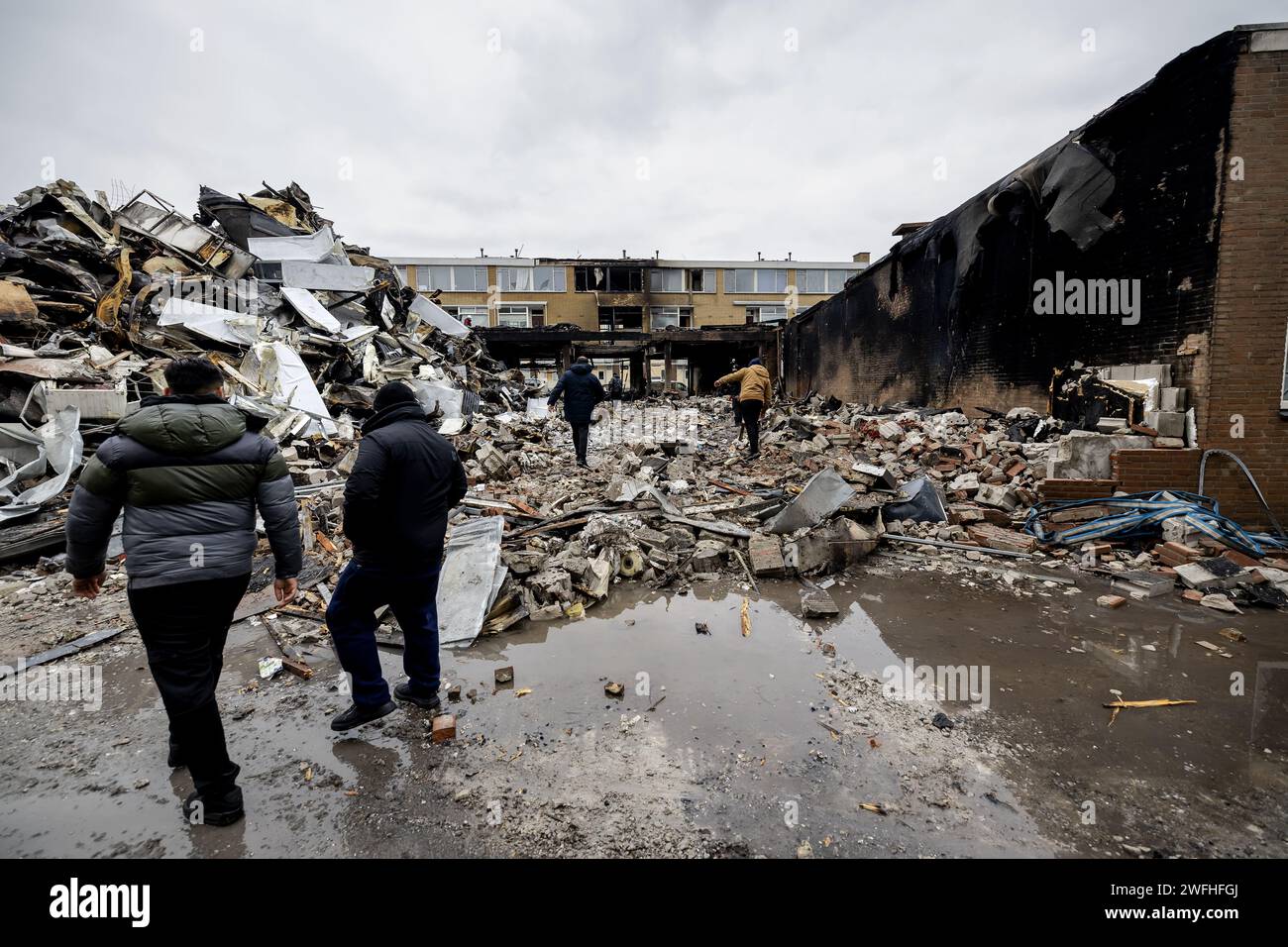 ROTTERDAM - Family members enter the site where an explosion took place ...