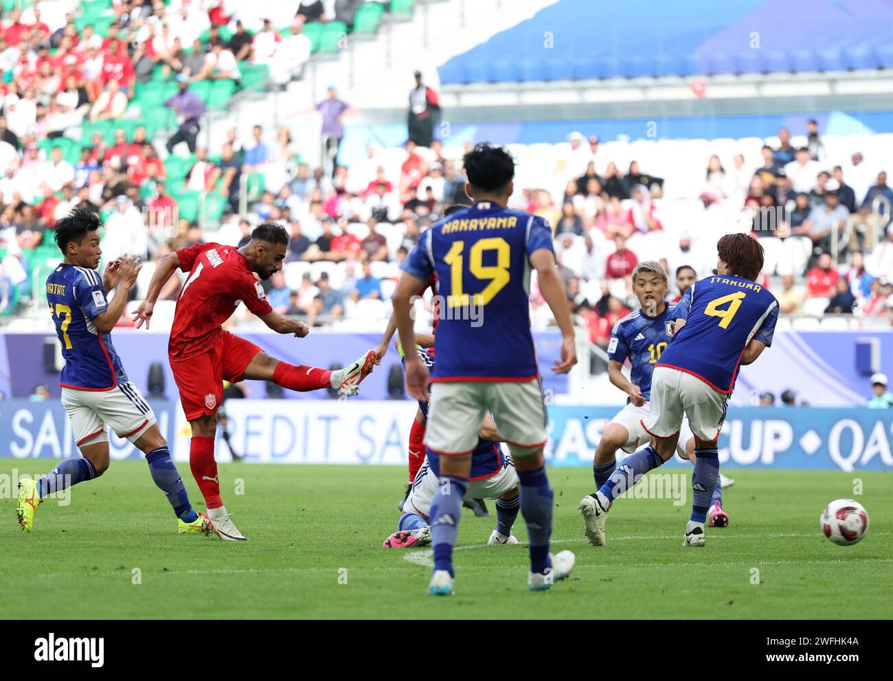 Doha, Qatar. 31st Jan, 2024. Bahrain's Ali Madan (2nd L) shoots during ...