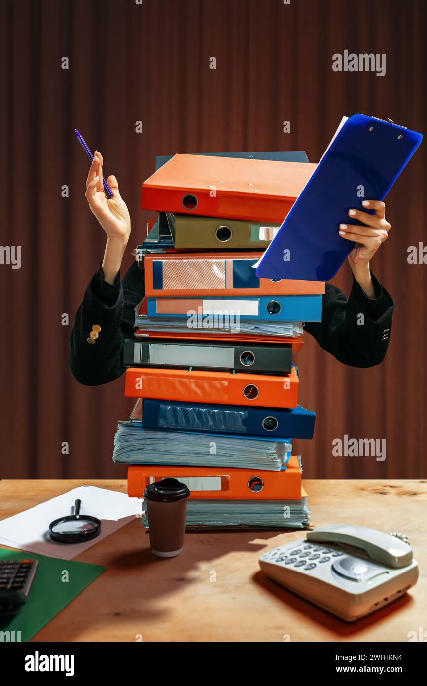 Chaos of poor scheduling. Person with tall stack of colorful binders ...