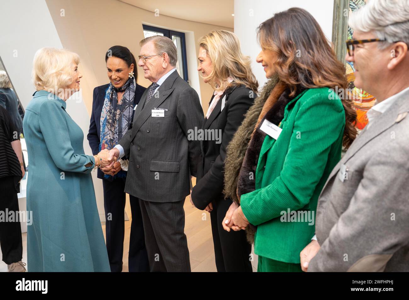 Queen Camilla shakes hands with Sir Gerald Ronson during her visit to ...
