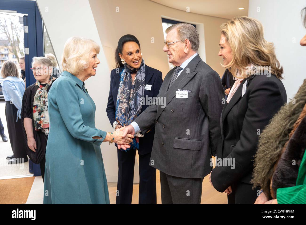 Queen Camilla shakes hands with Sir Gerald Ronson during her visit to ...