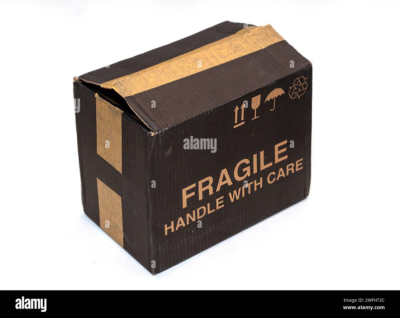 Closed cardboard transport box with fragile sign written outside on ...