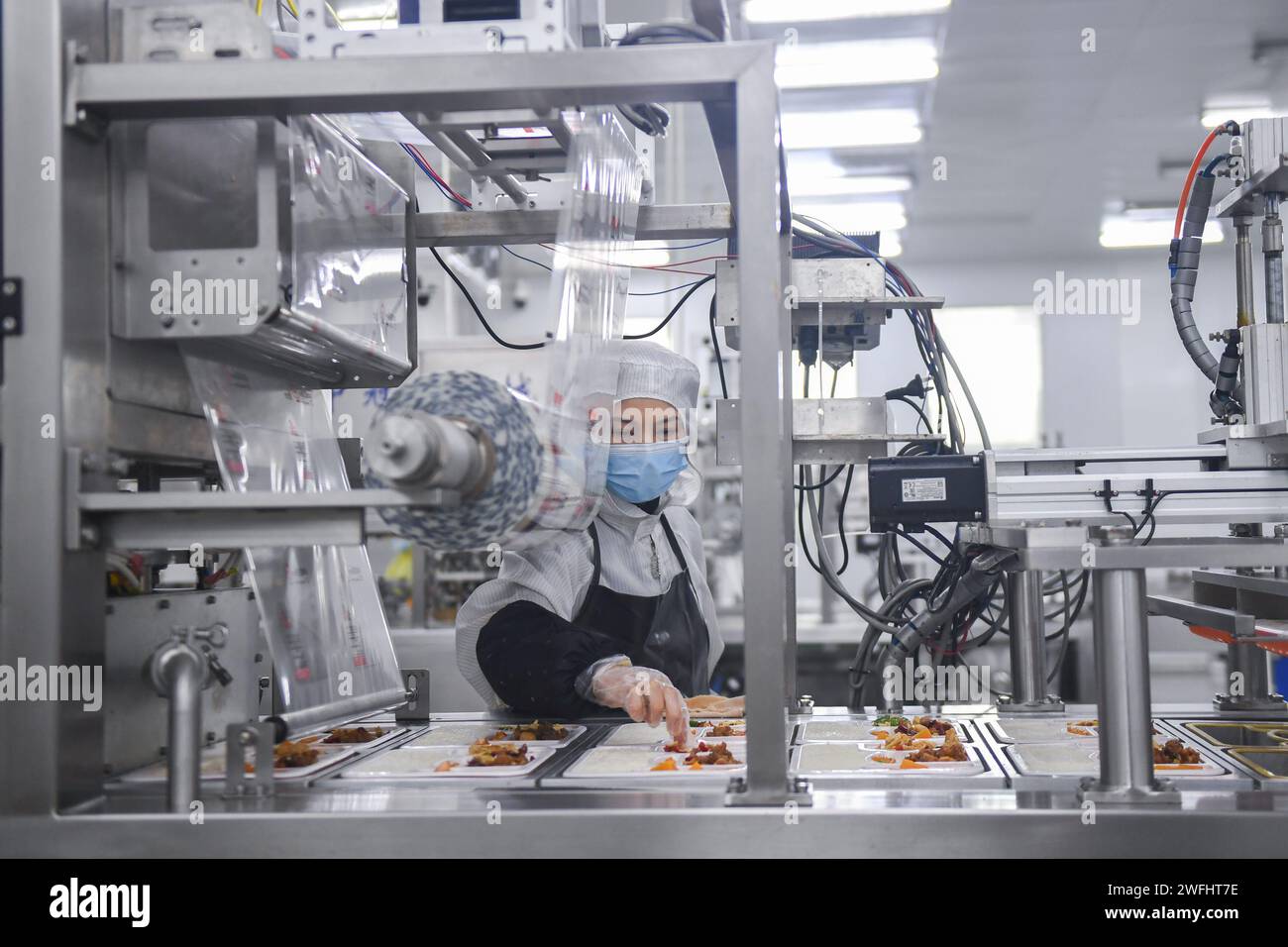 (240131) -- WUHAN, Jan. 31, 2024 (Xinhua) -- A staff member packs boxed ...