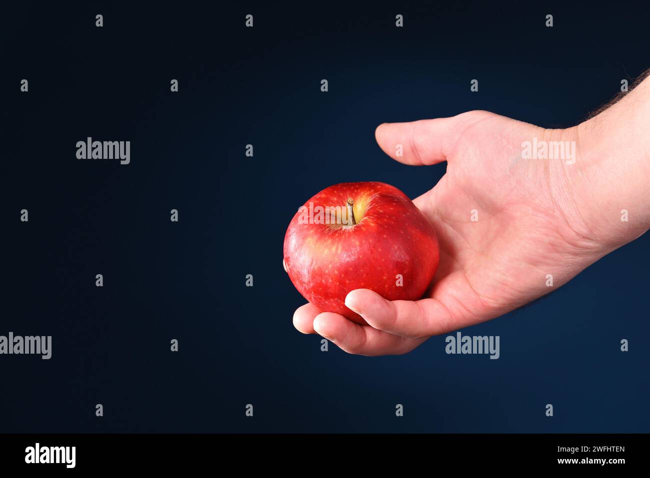 Hand holding red apple dark hi-res stock photography and images - Alamy