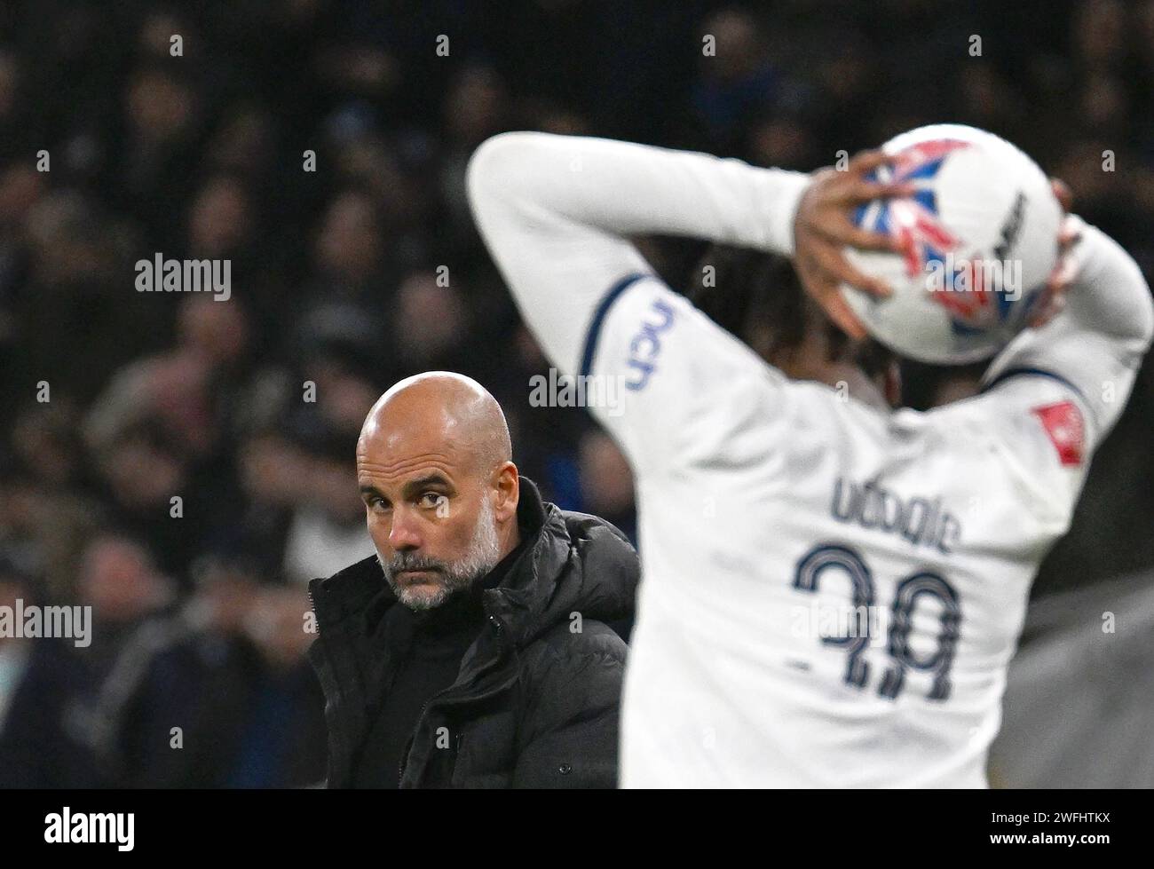 Pep Guardiola , the Manchester City Manager looks on at Destiny Udogie ...