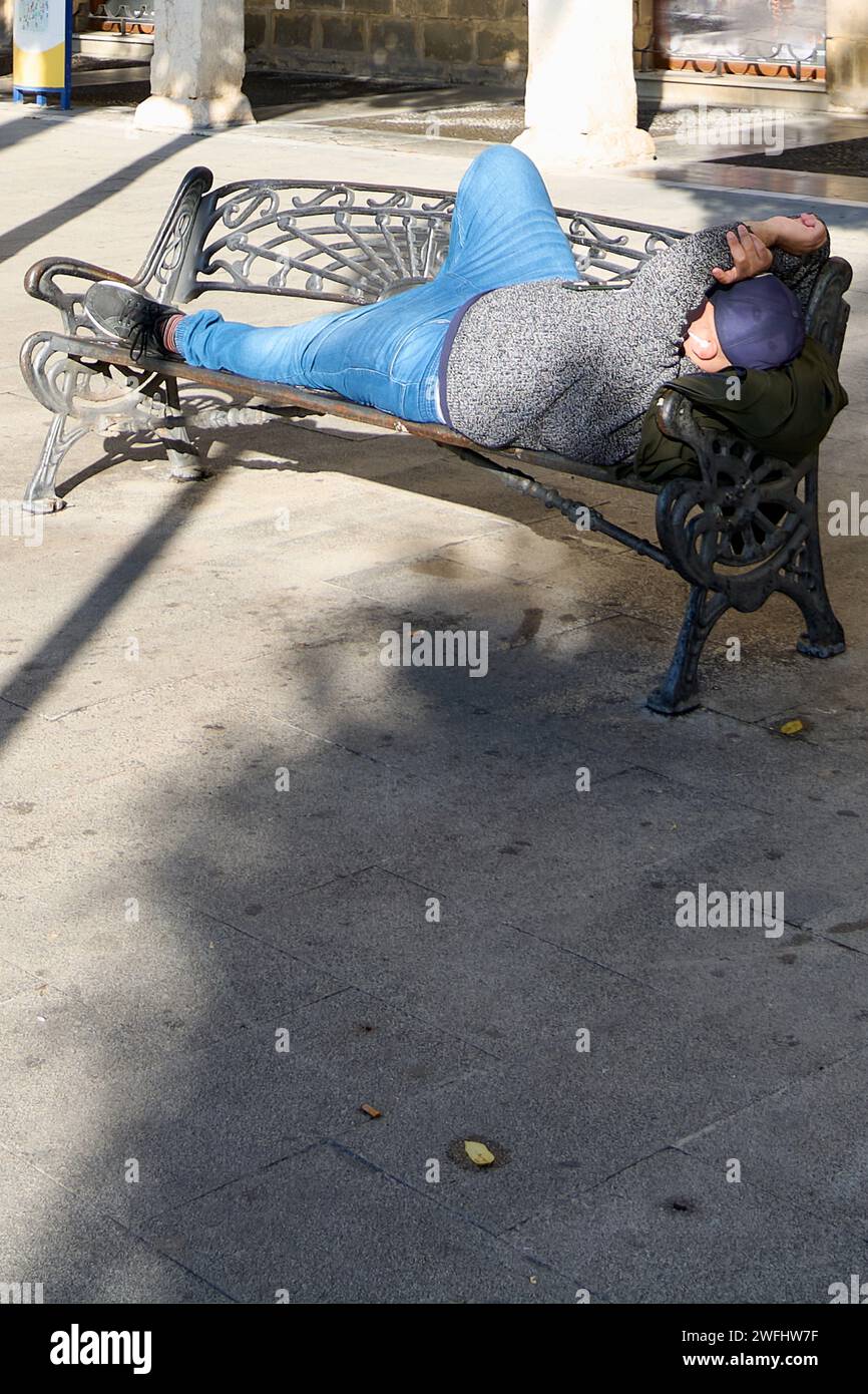 Urban rest, unrecognizable person on a public bench...Person relaxing ...