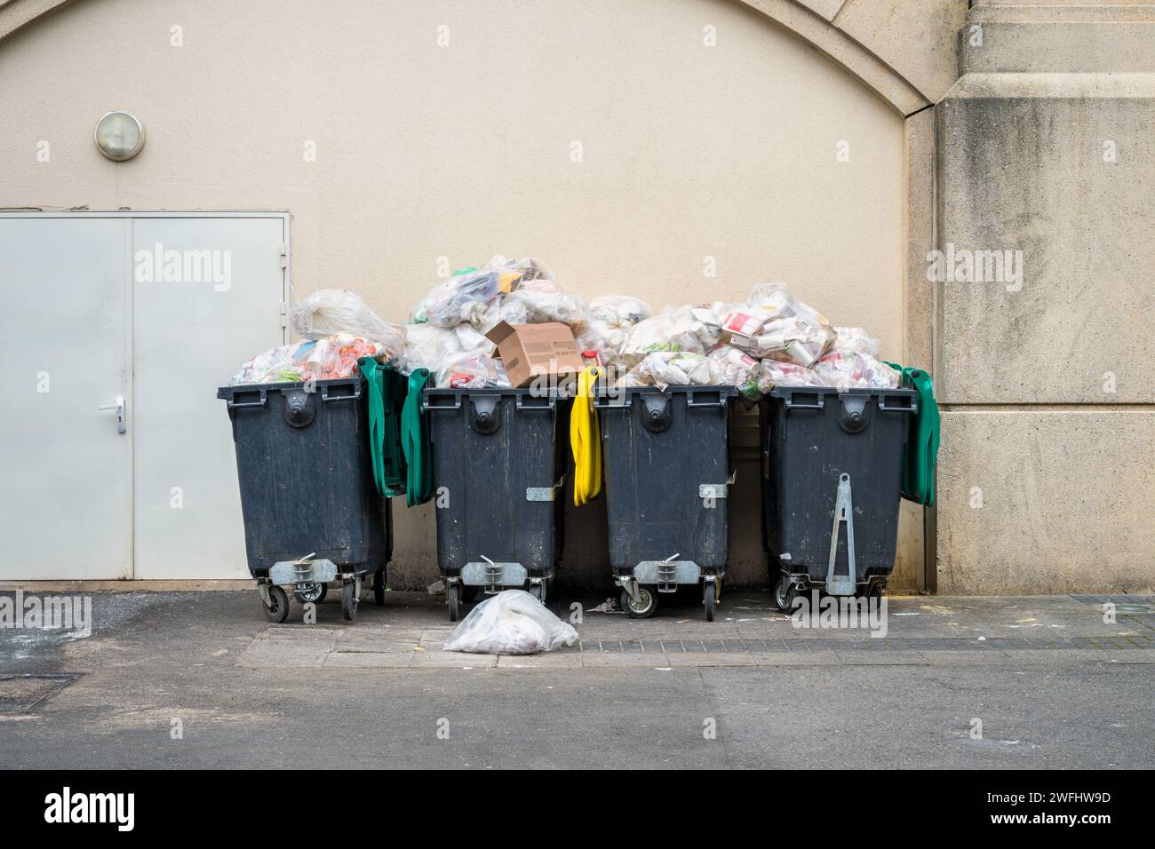Full Garbage Cans in Alley outside Shopping Mall Stock Photo - Alamy