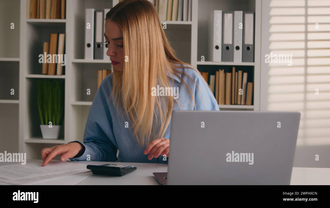 Caucasian woman using calculator laptop app calculate costs business ... Caucasian woman using calculator laptop app calculate costs business ...