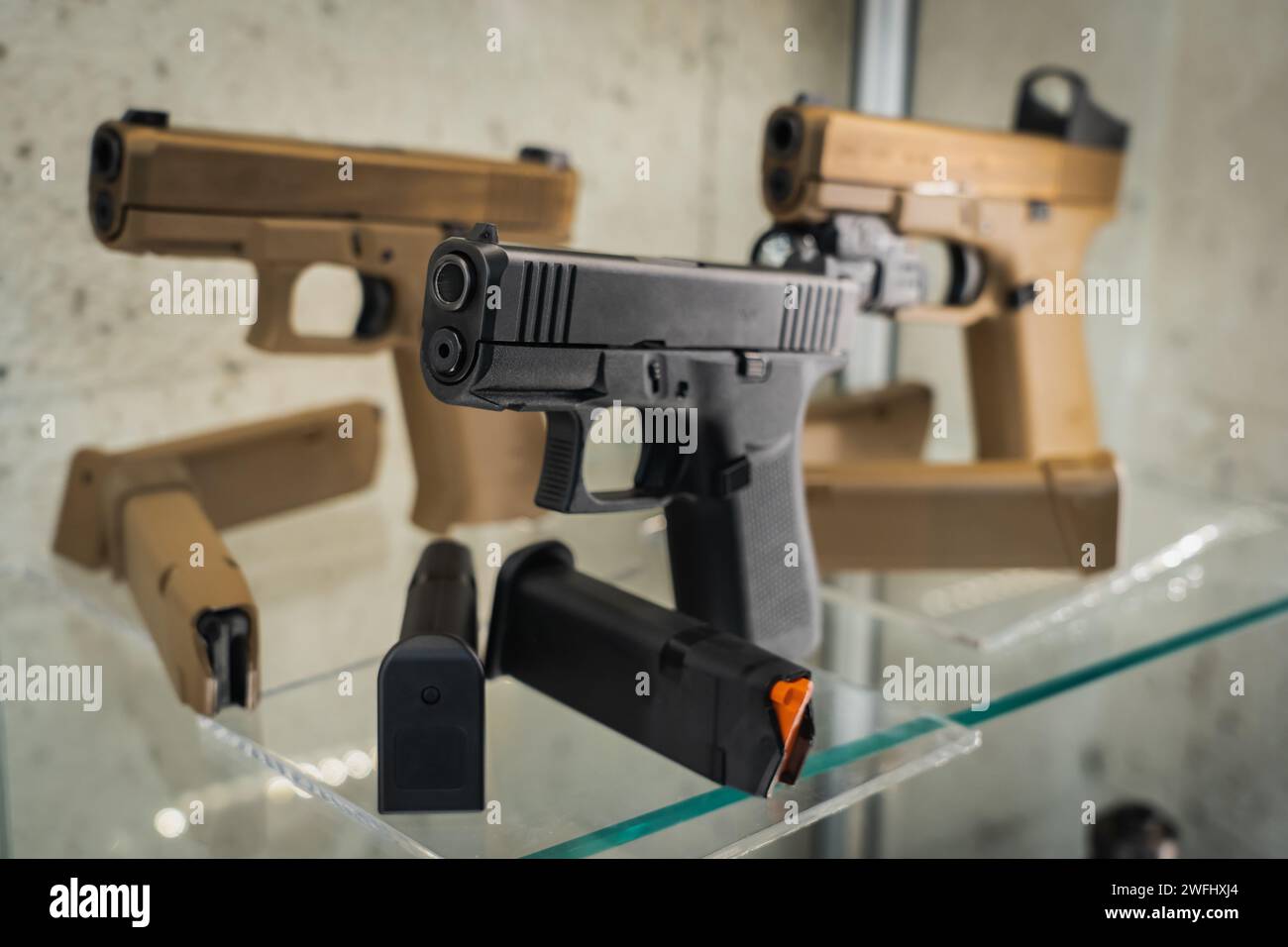 Firearms, pistols on display in a store, close-up photo. High quality ...