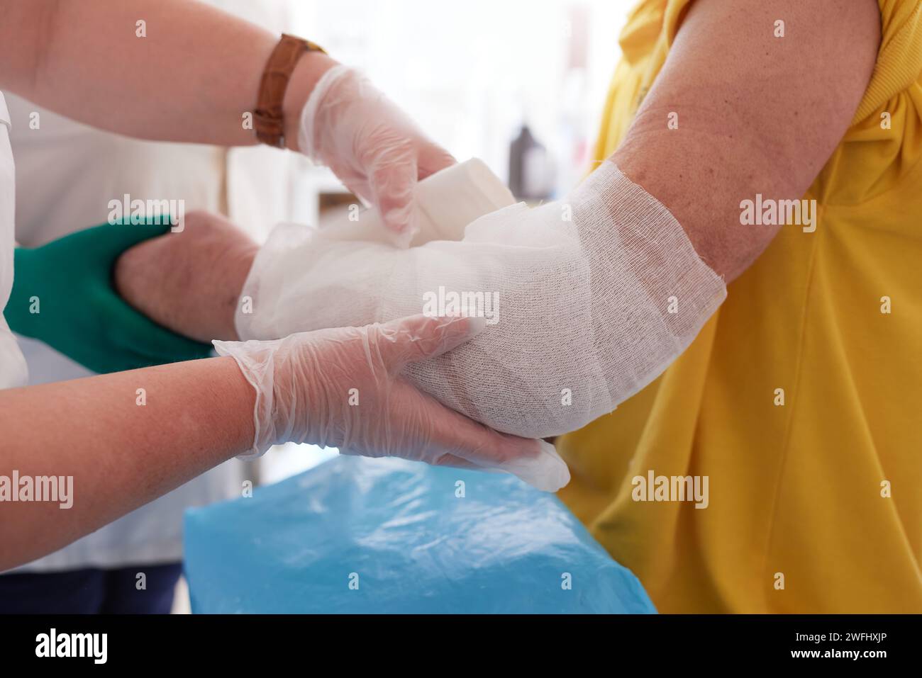 doctor puts a plaster on the arm of a patient in the hospital with a ...