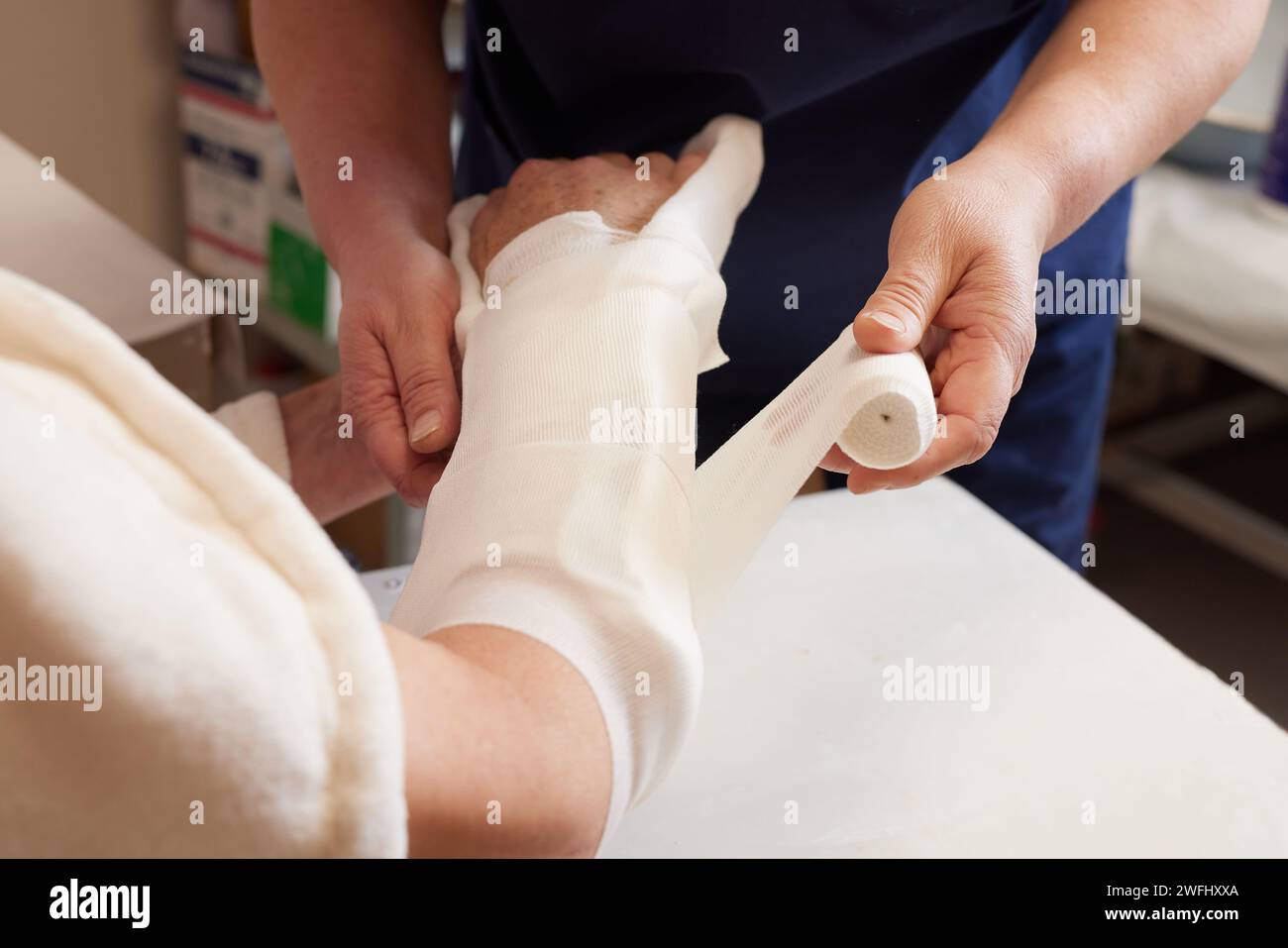 doctor puts a plaster on the arm of a patient in the hospital with a ...