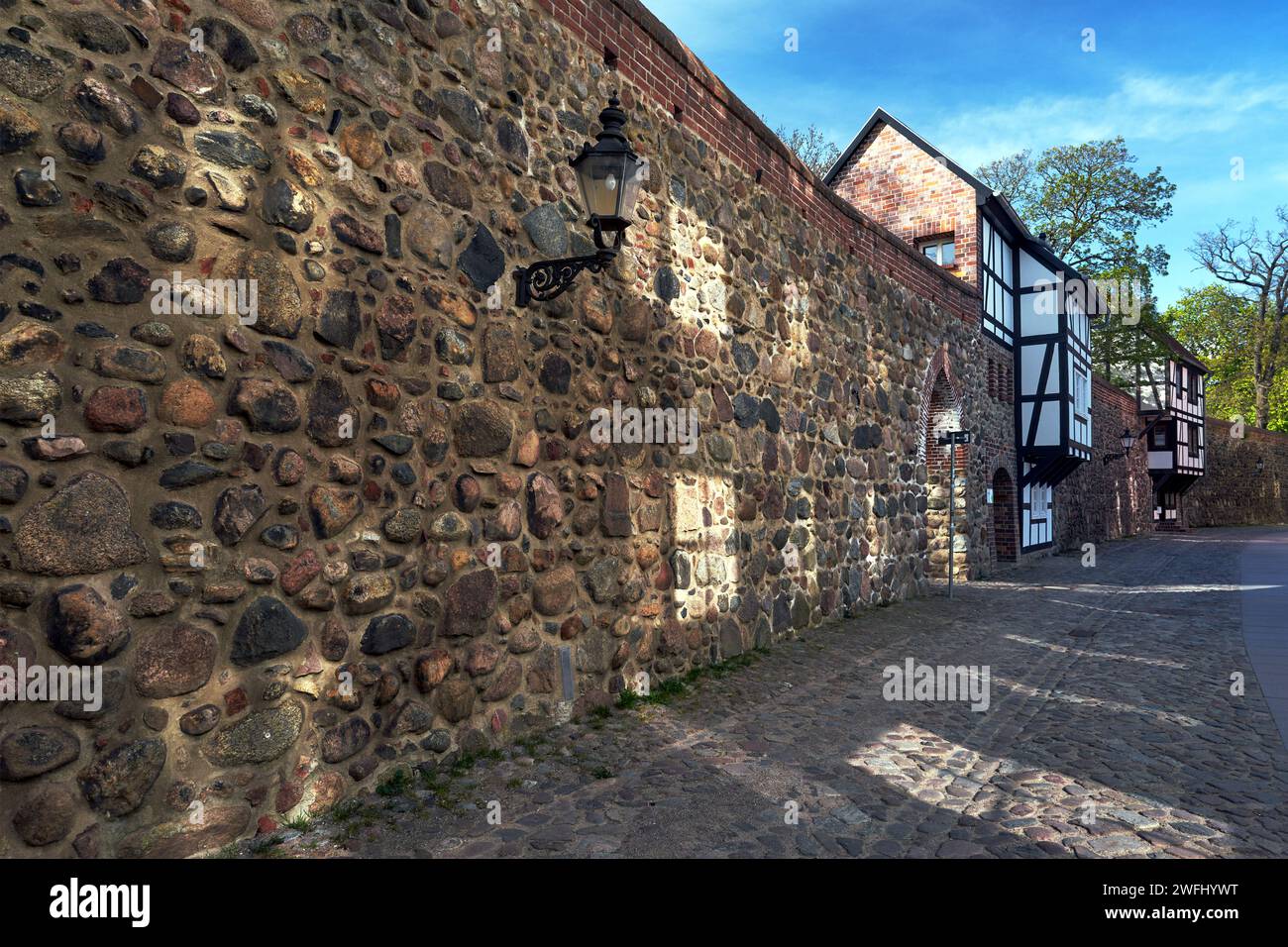 Stone, medieval walls with a historic, multi -story house in the city ...