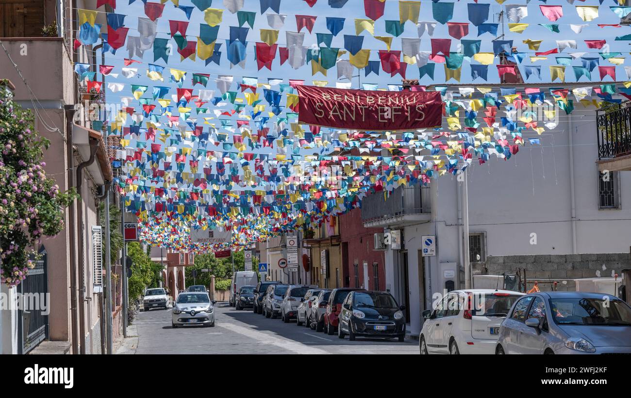 Rows of flags suspended above a street in the town of Pula, Sardinia ...
