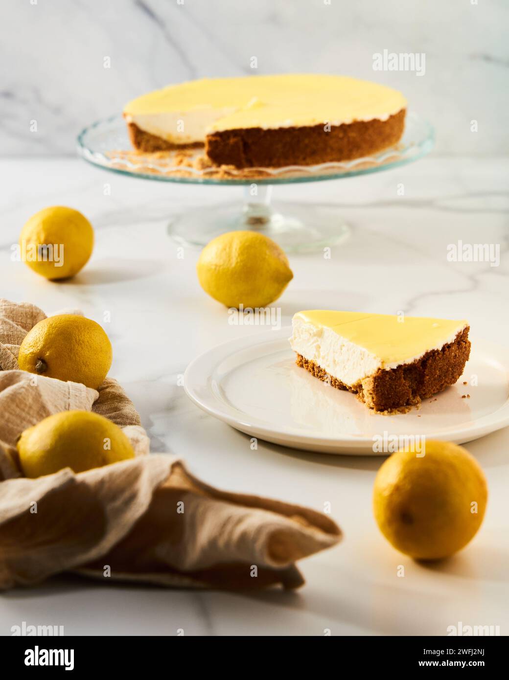 Mascarpone cheesecake with lemon curd and shortbread base. White marble ...