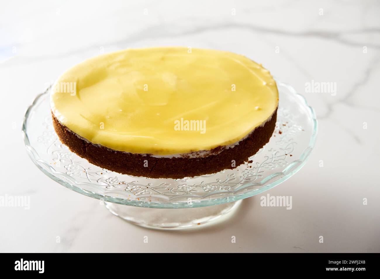 Mascarpone cheesecake with lemon curd and shortbread base. White marble ...