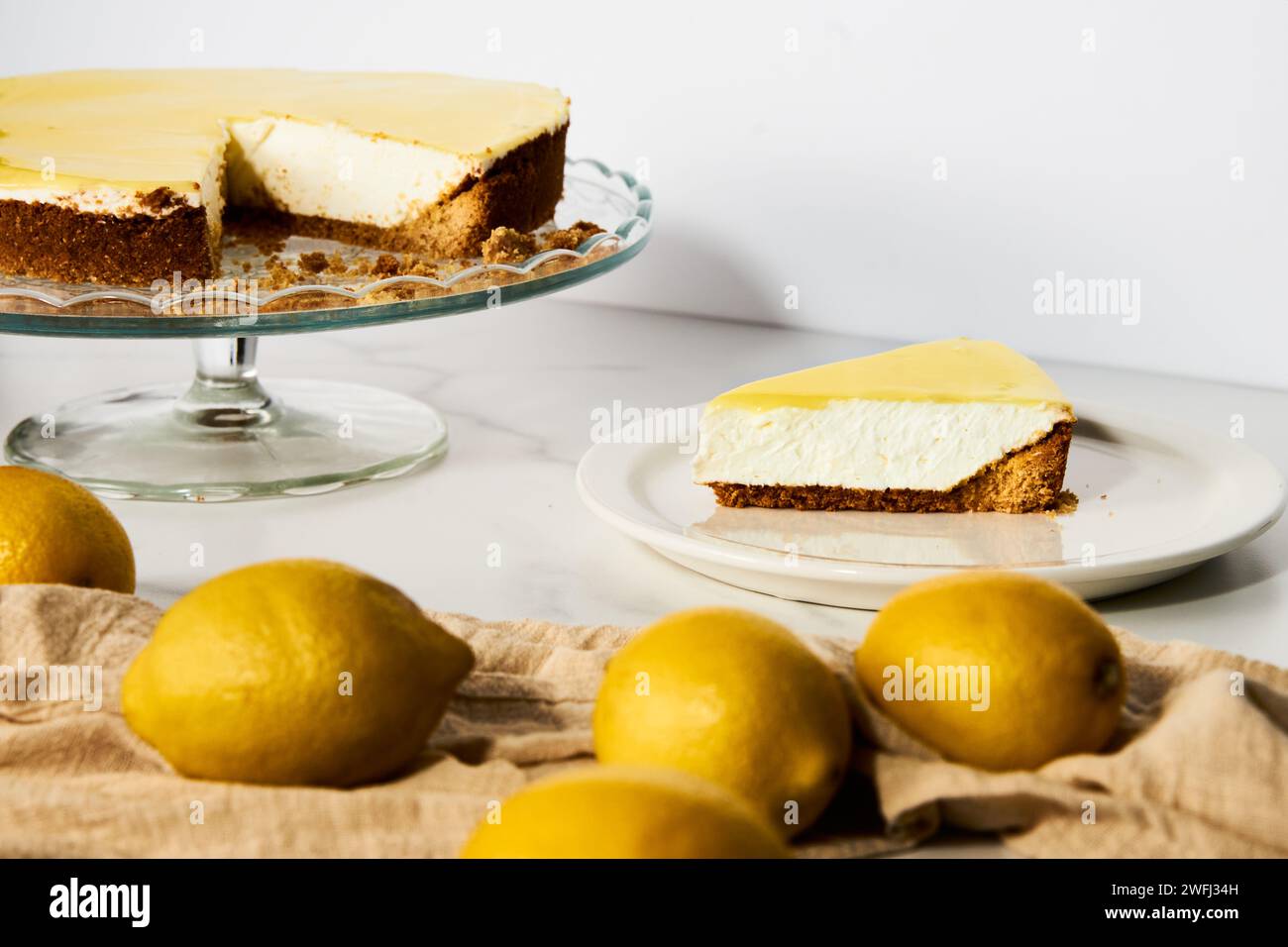 Mascarpone cheesecake with lemon curd and shortbread base. White marble ...