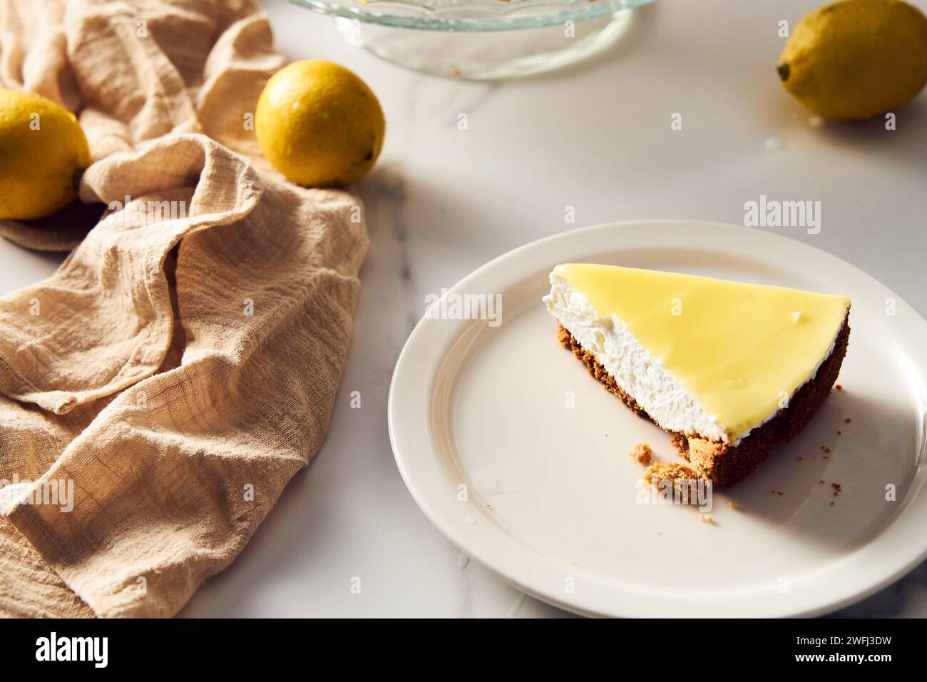 Mascarpone cheesecake with lemon curd and shortbread base. White marble ...