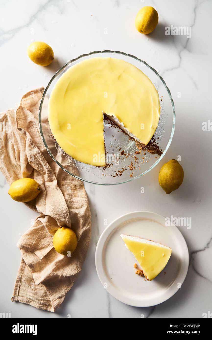 Mascarpone cheesecake with lemon curd and shortbread base. White marble ...