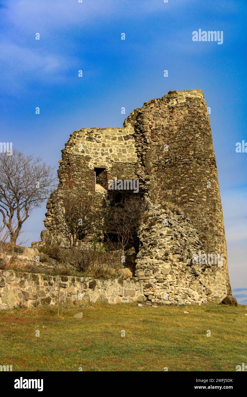 Stone ruins of ancient fortress in Georgia. Sunny autumn day, blue sky ...