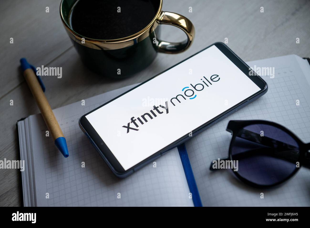 In this photo illustration a Xfinity Mobile logo seen displayed on a ...
