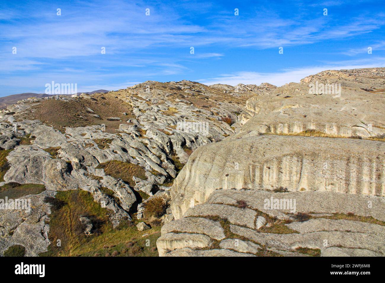 Mountains near Gori and Uplistsikhe in Georgia. Rocks with grass. Blue ...