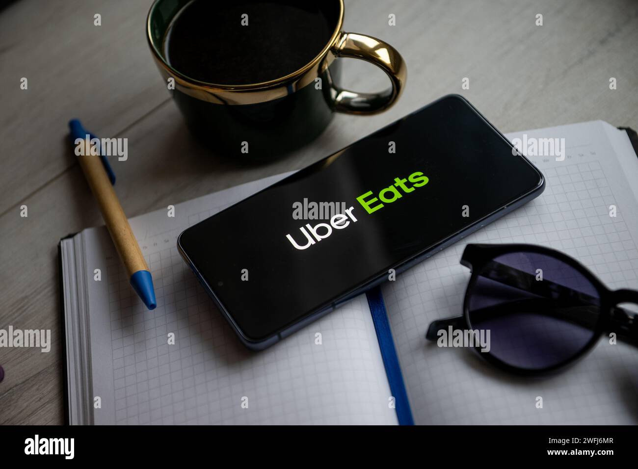 In this photo illustration a Uber Eats logo seen displayed on a ...
