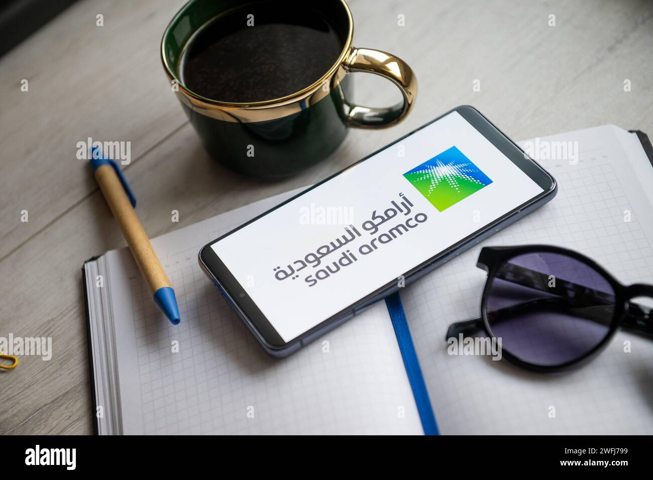 In this photo illustration a Saudi Aramco logo seen displayed on a ...