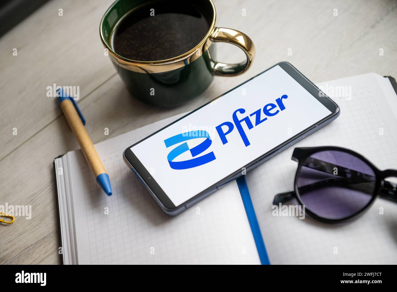 In this photo illustration a Pfizer logo seen displayed on a smartphone ...
