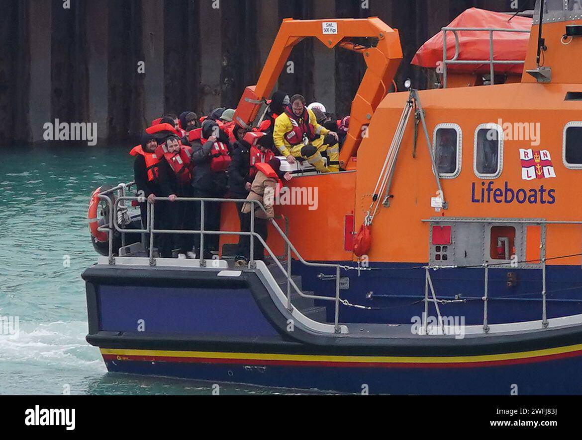 A group of people thought to be migrants are brought in to Dover, Kent ...