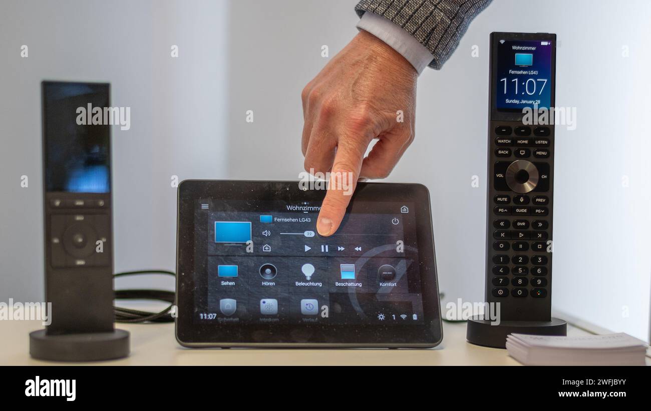 A man using multiple mobile devices, including a cell phone and an iPad ...