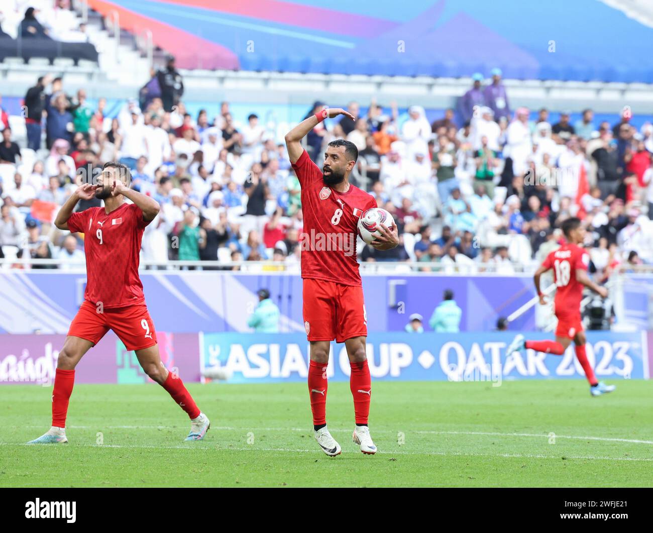 Doha, Qatar. 31st Jan, 2024. Bahrain's Mohamed Marhoon (C) gestures to ...
