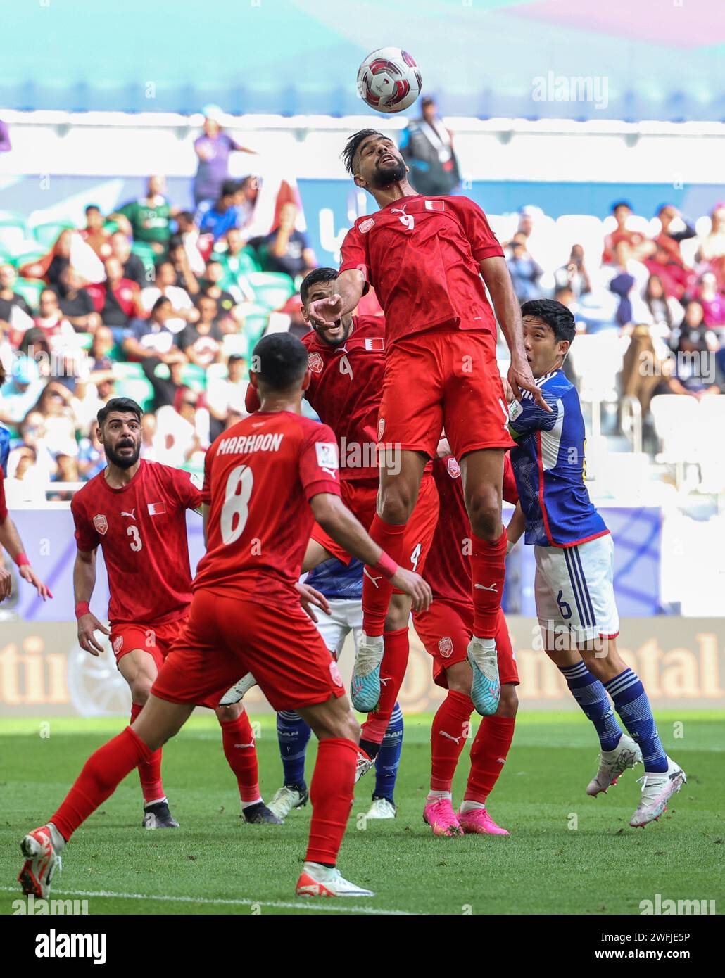 Doha, Qatar. 31st Jan, 2024. Bahrain's Abdulla Yusuf (top) vies for a ...