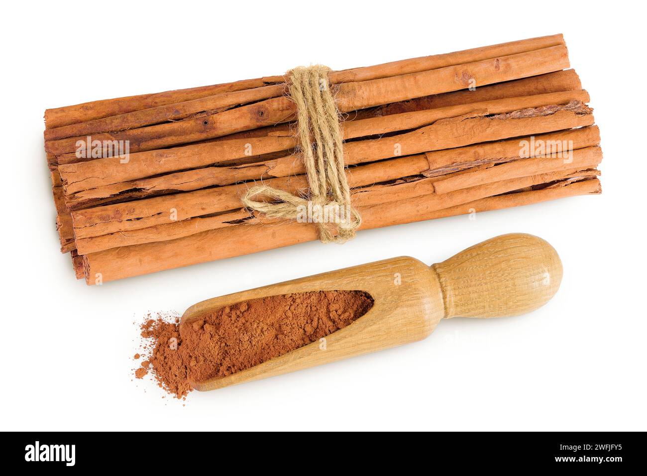 Cinnamon sticks with powder in wooden scoop isolated on white ...