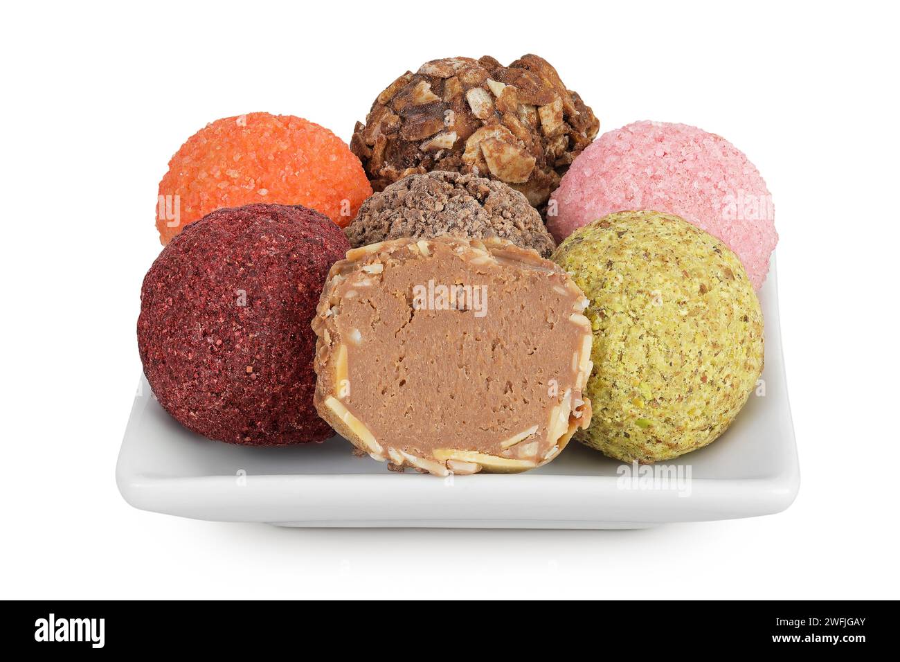 A variety of different truffles in a ceramic bowl Isolated on a white ...