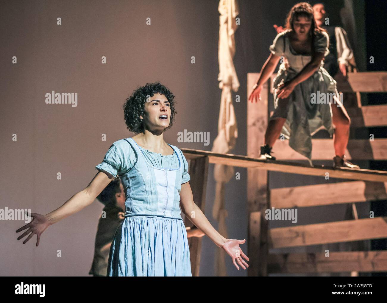 London, UK. 31st Jan, 2024. The ensemble of performers in a scene ...