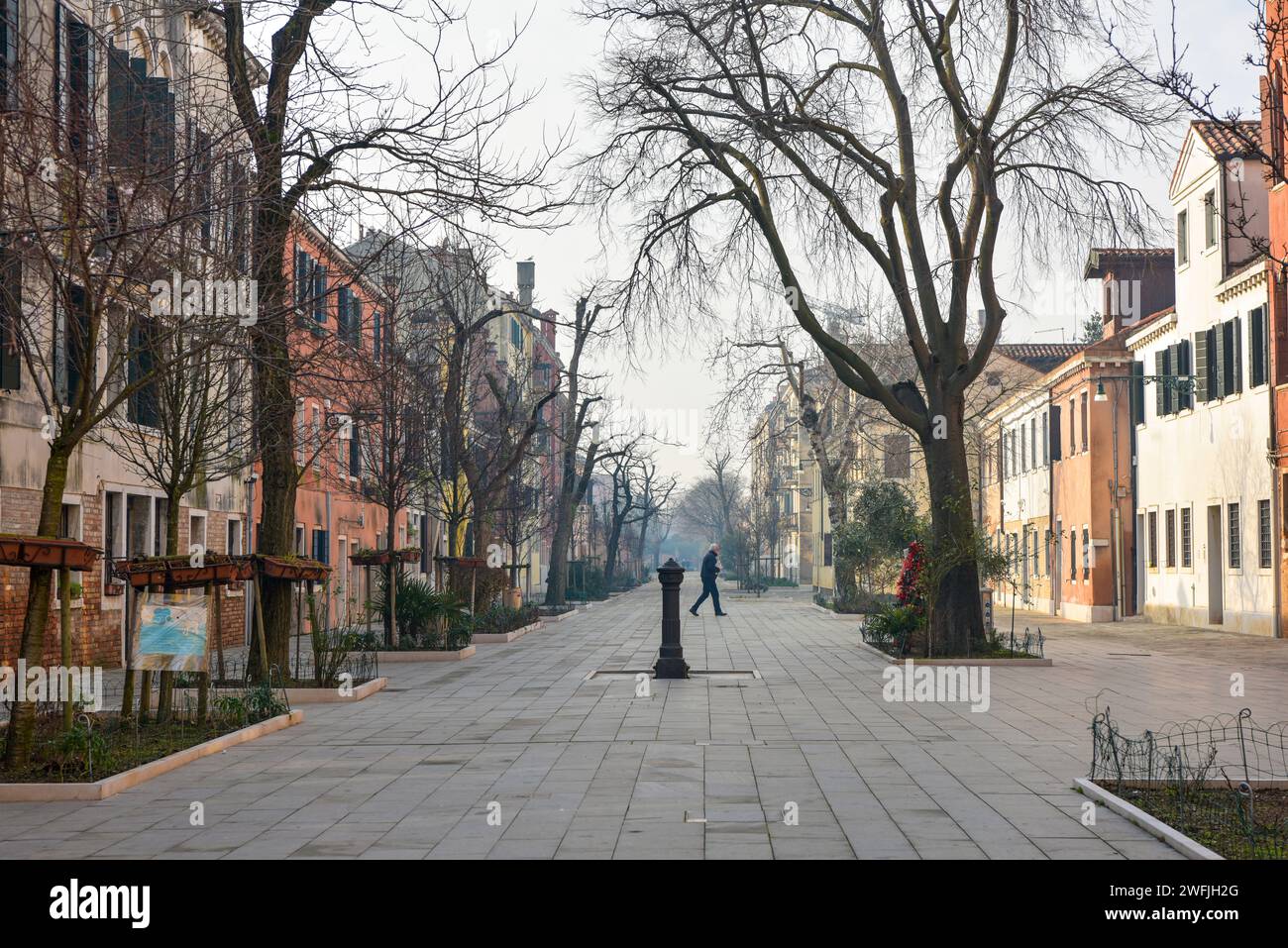 A local Venice resident walks across the pavement to collect his daily ...