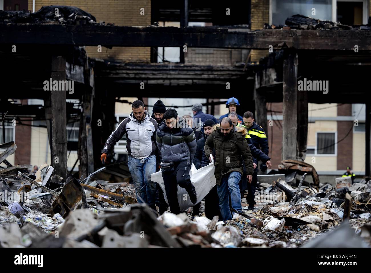 ROTTERDAM - Family members remove the remains of one of the victims in ...