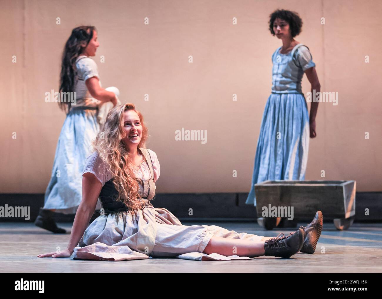 London, UK. 31st Jan, 2024. The ensemble of performers in a scene ...